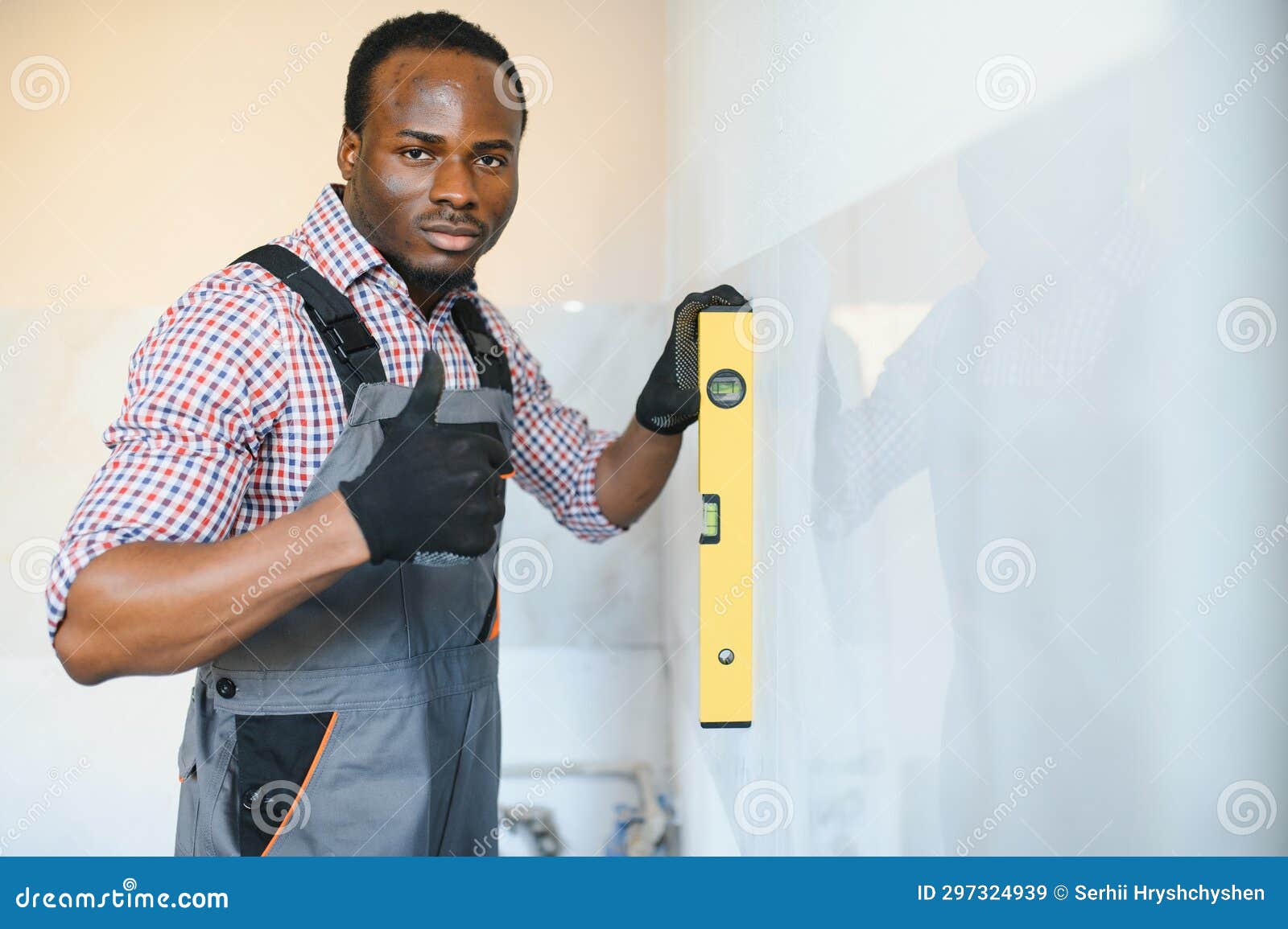 African American Worker Installing Wall Tile with Vacuum Holder Indoors ...