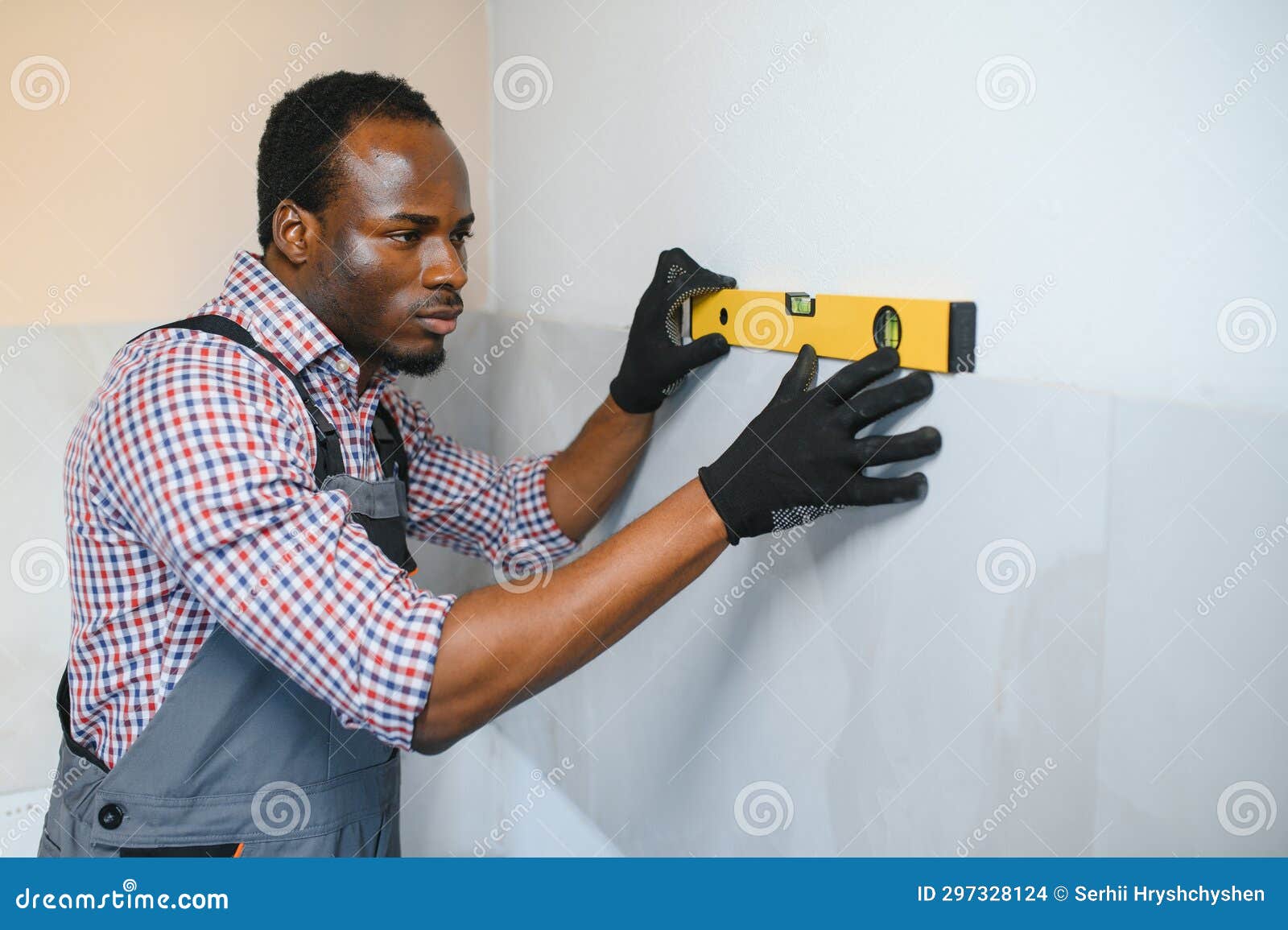African American Worker Installing Wall Tile with Vacuum Holder Indoors ...