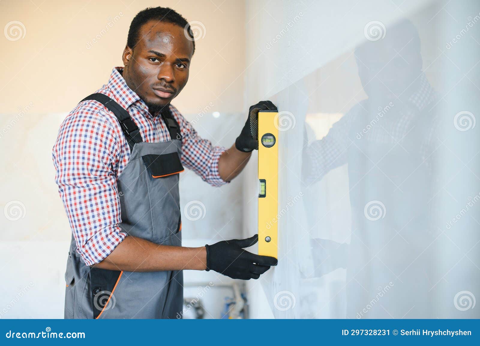 African American Worker Installing Wall Tile with Vacuum Holder Indoors ...