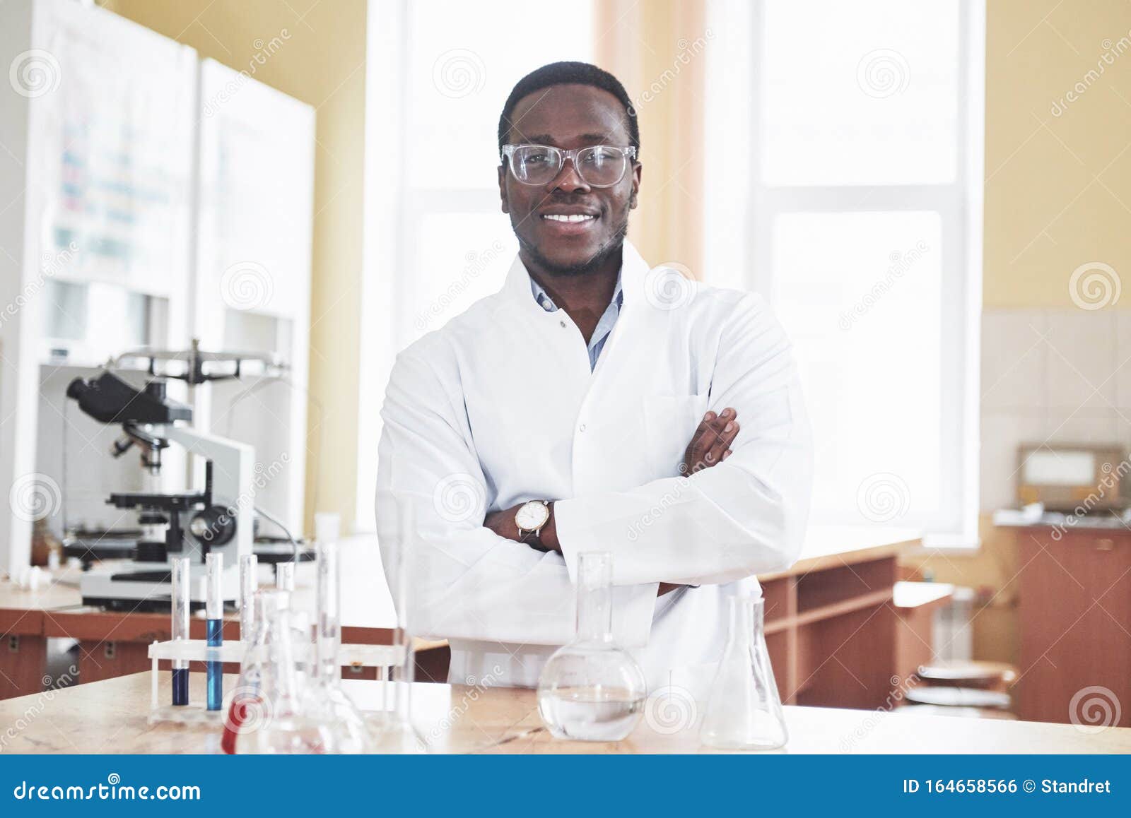 An African American Worker Works in a Laboratory Conducting Experiments ...