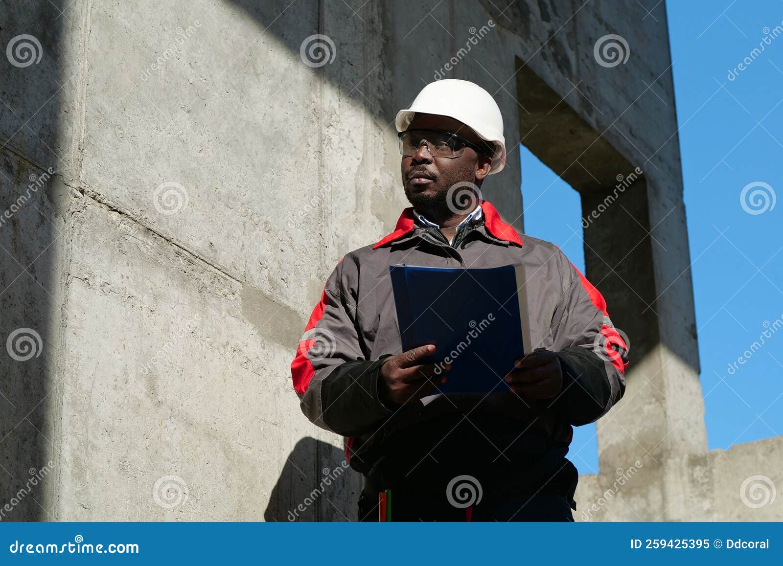 African American Workman at Construction Site with Work Papers Stock ...