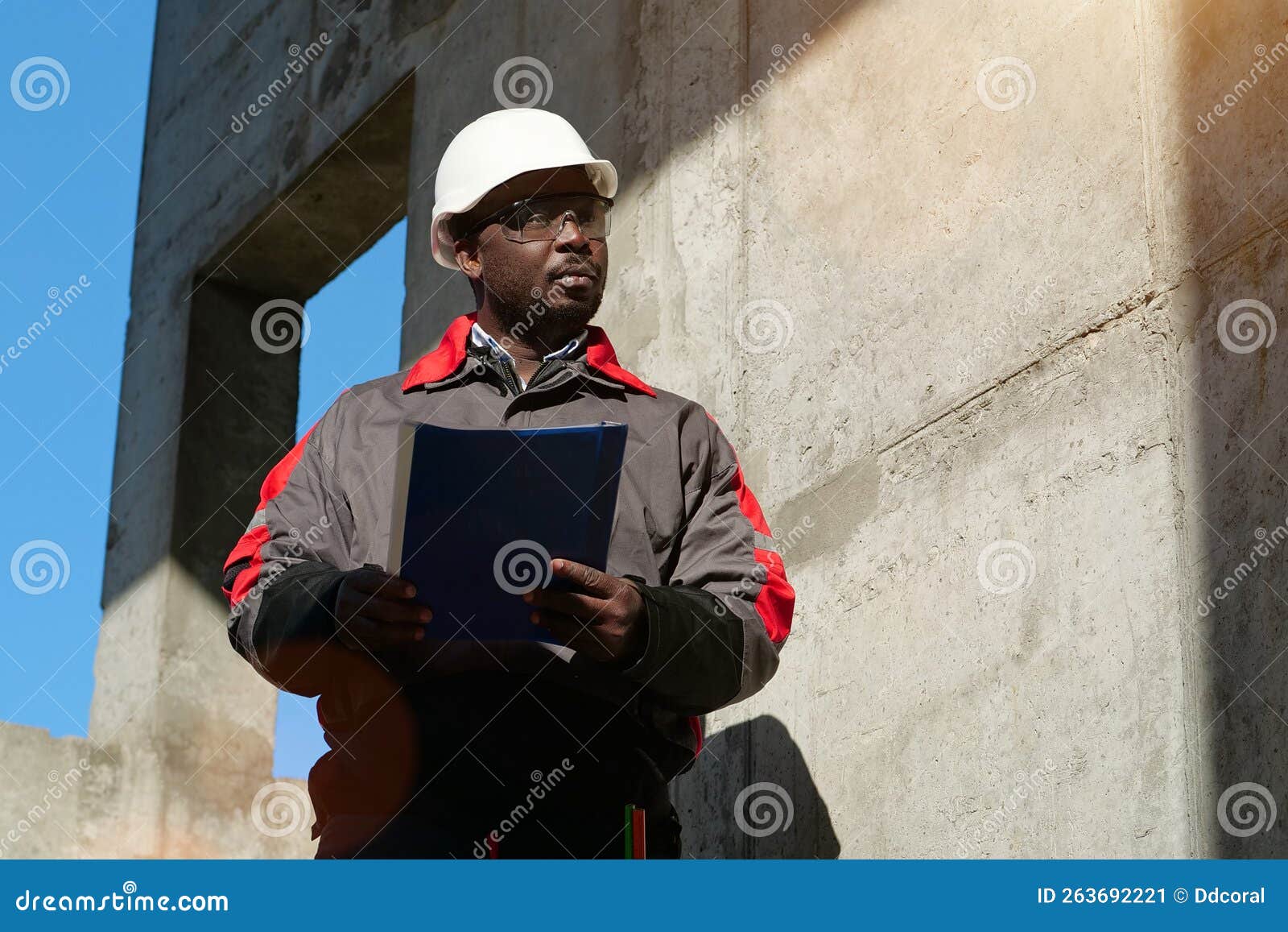 African American Workman at Construction Site with Work Papers Stock ...