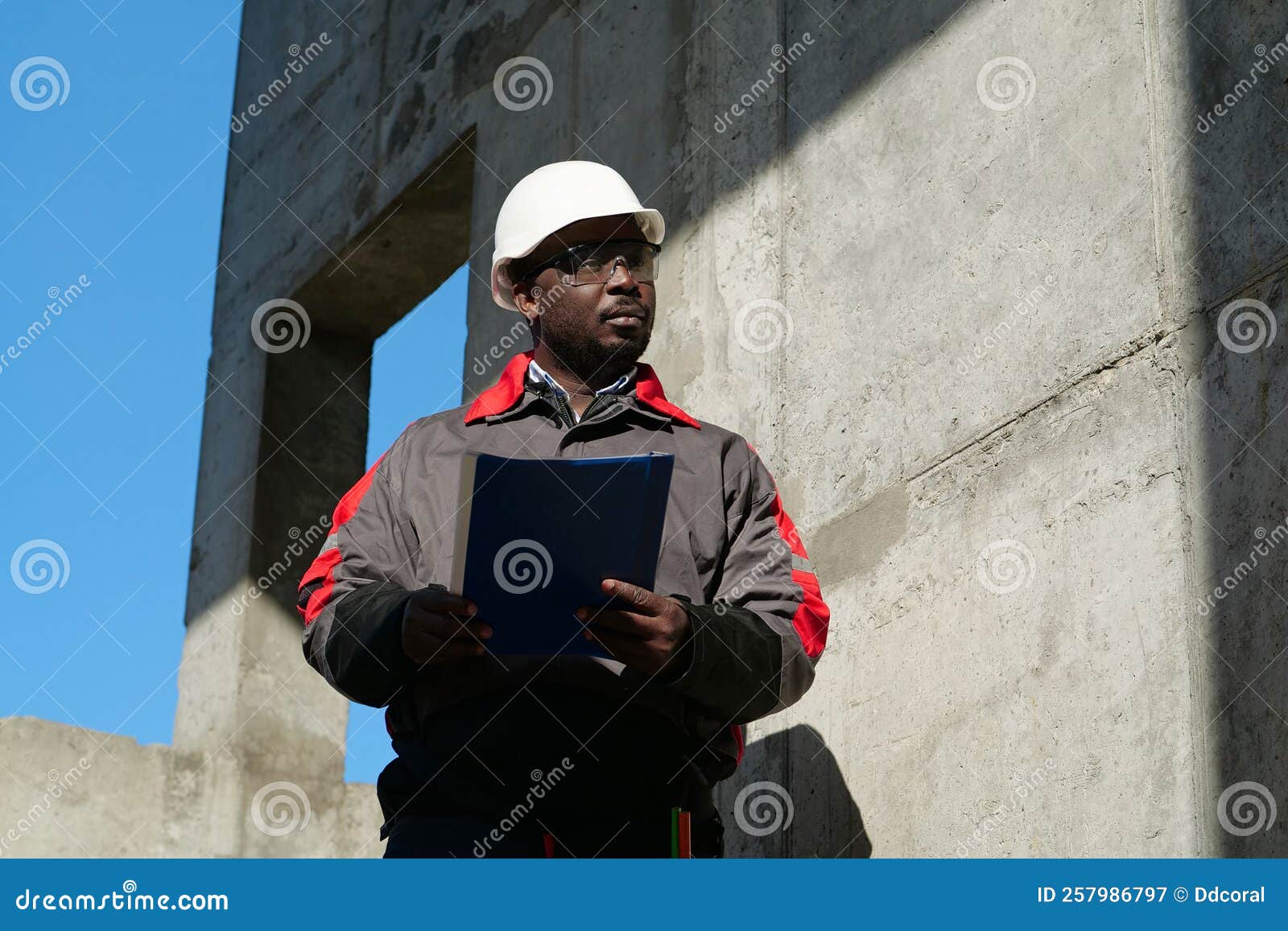 African American Workman at Construction Site with Work Papers Stock ...