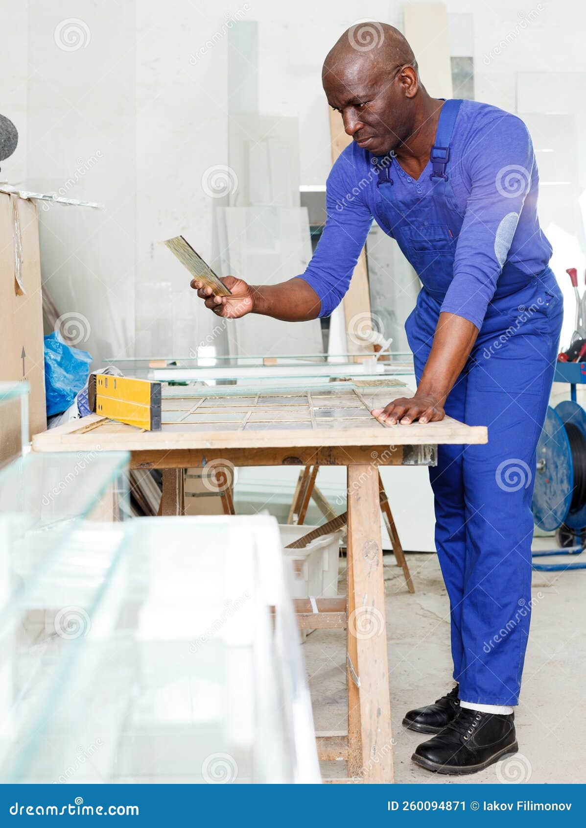 Workman working with glass stock image. Image of machine - 260094871