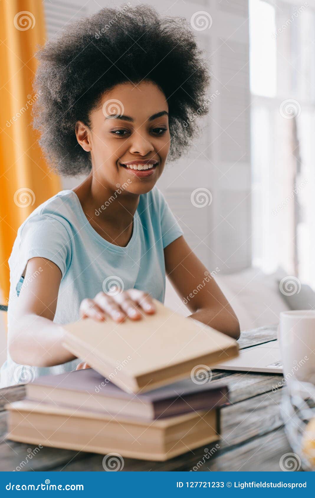 African American Young Woman Choosing Book from Stack Stock Image ...