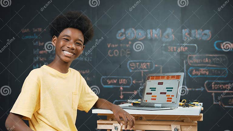 African Boy Programing System and Turn Around To Smile To Camera ...