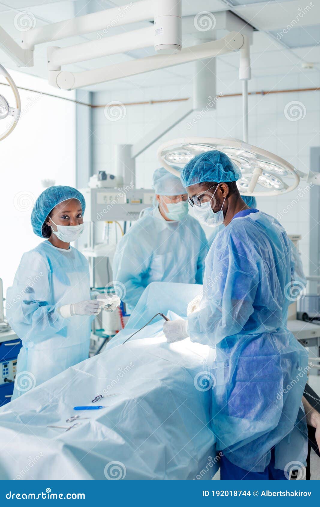 African and Caucasian Doctors Perform the Risky Surgery Stock Photo ...