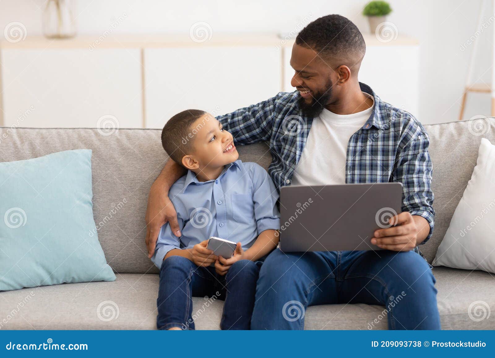 African Daddy and Little Son Using Digital Tablet at Home Stock Photo ...