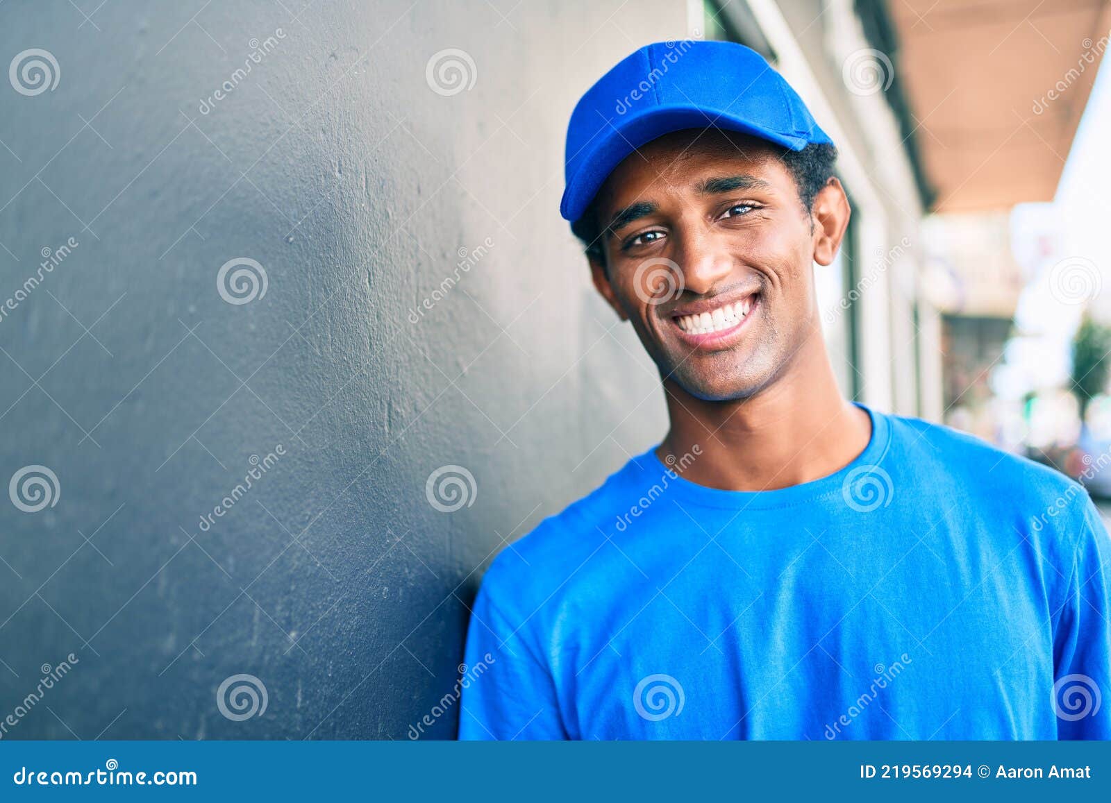 African Delivery Man Wearing Courier Uniform Outdoors Stock Photo ...