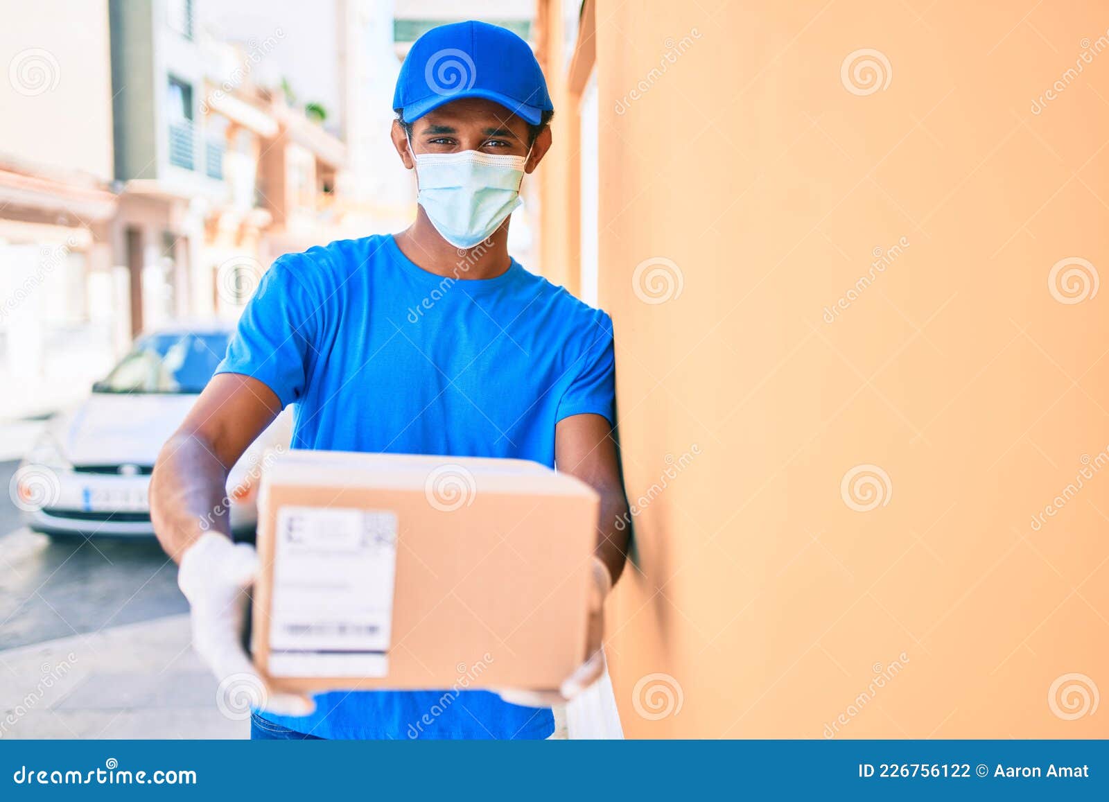 African Delivery Man Wearing Courier Uniform Outdoors Wearing