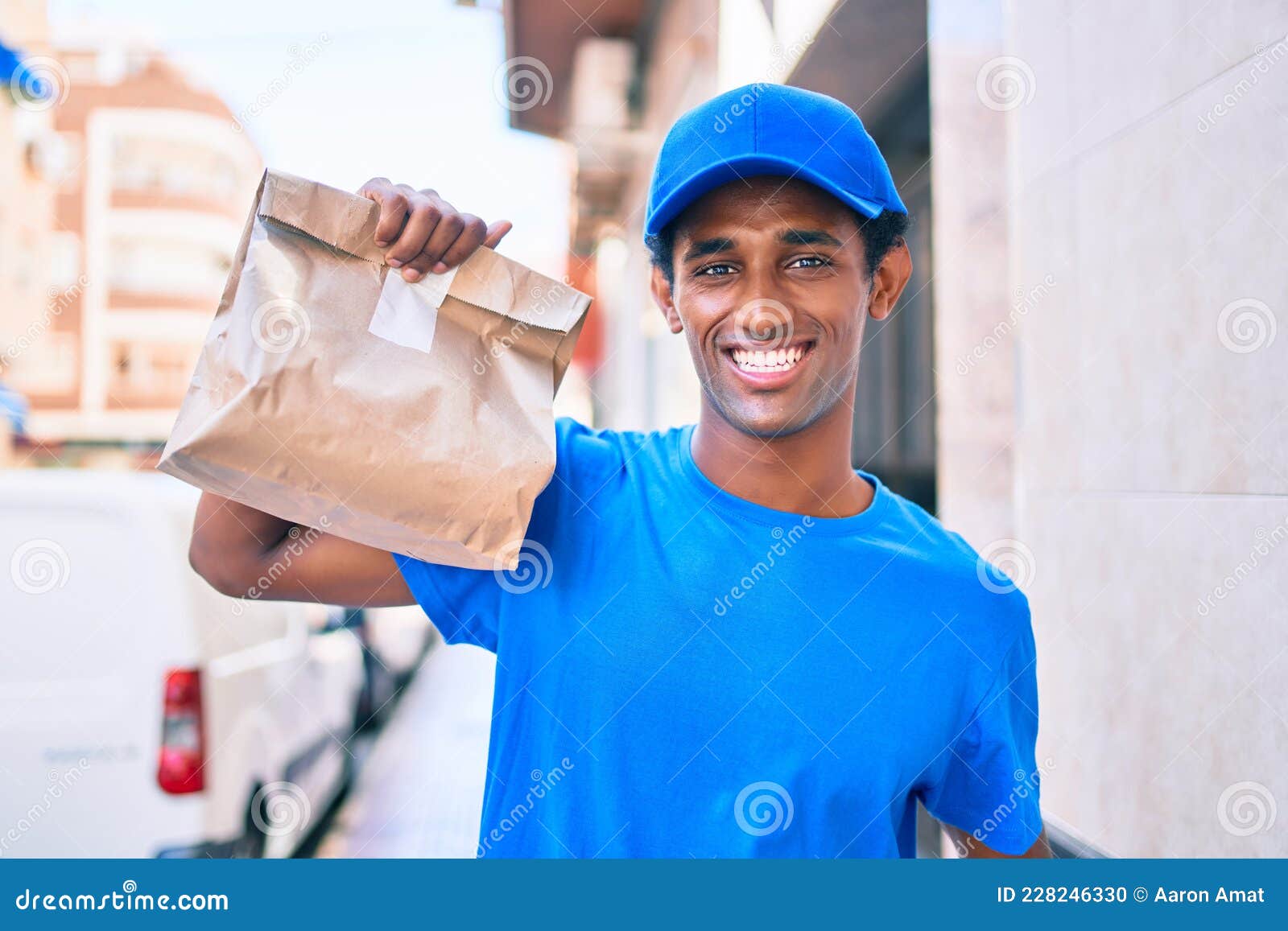 African Delivery Man Wearing Courier Uniform Outdoors Holding Take Away