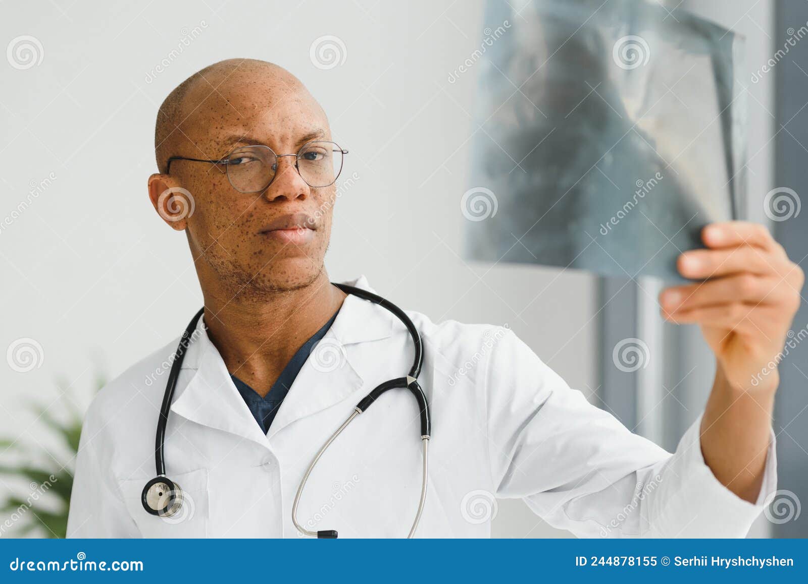 African Doctor Looking at a Radiography. Stock Image - Image of black ...