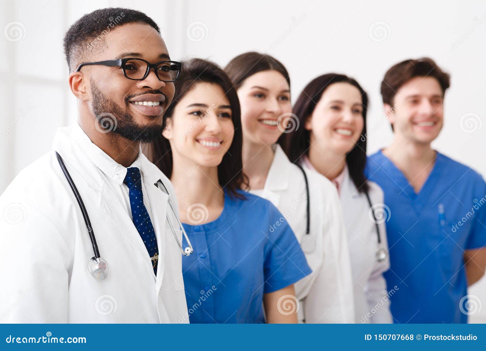 African Doctor Standing in Row with Team Stock Photo - Image of ...