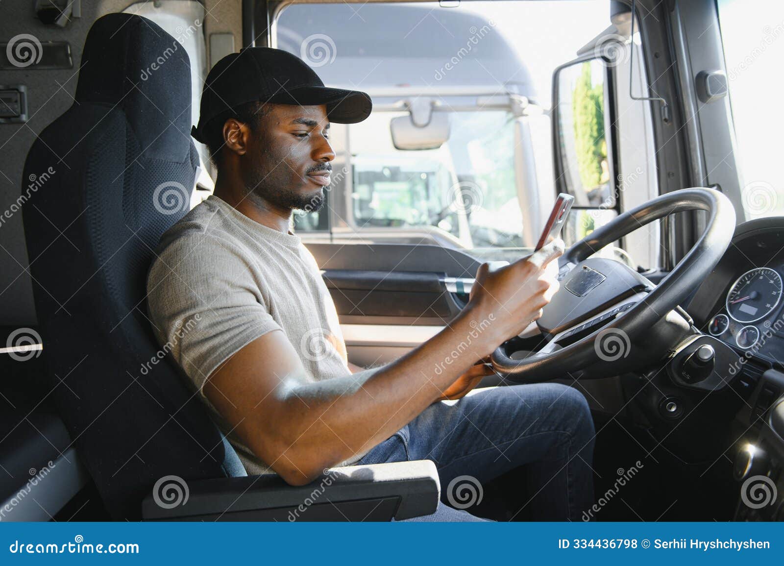 African Driver in the Cabin of a Truck Talking on the Phone Stock Photo ...