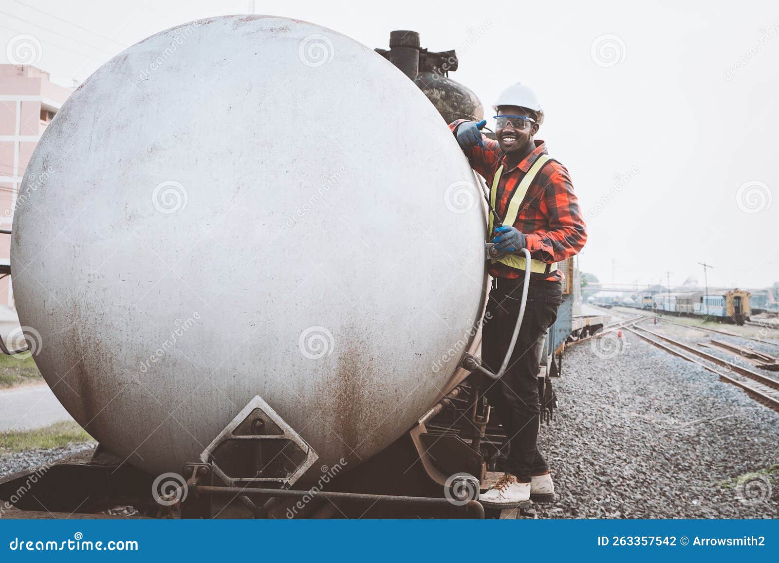 African Engineer Inspecting Oil or Fuel Tanks Transported by Train ...