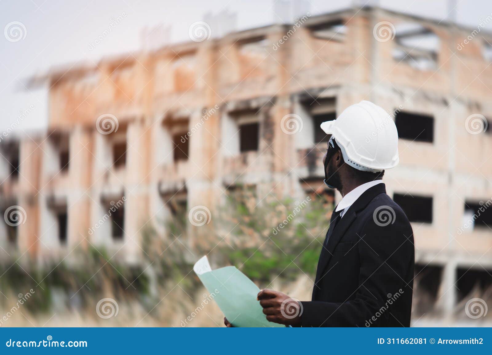 African Engineer Manager Checking Blueprint for Demolition Construction ...