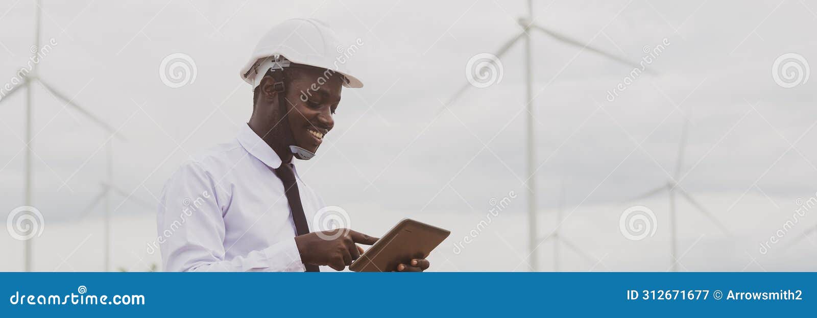 African Engineer Smile and Using Tablet with the Wind Turbine for ...