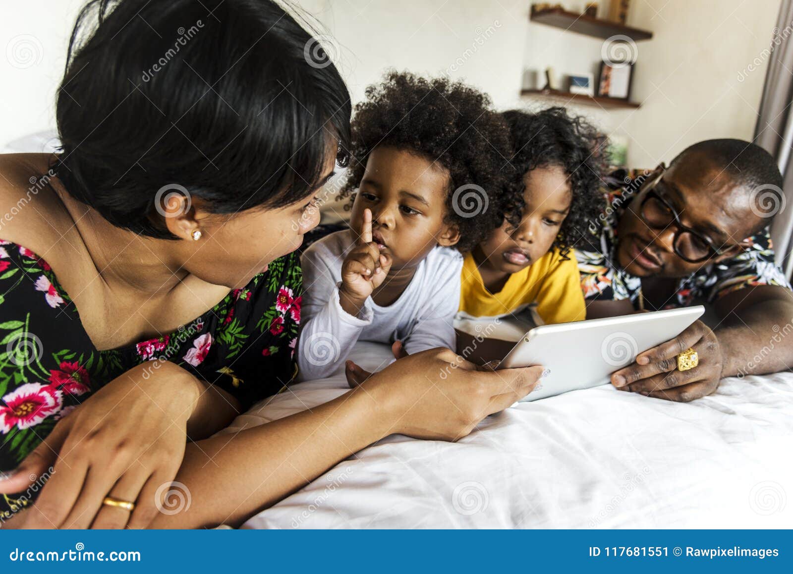 African Family on Bed Using a Tablet Stock Image - Image of father ...