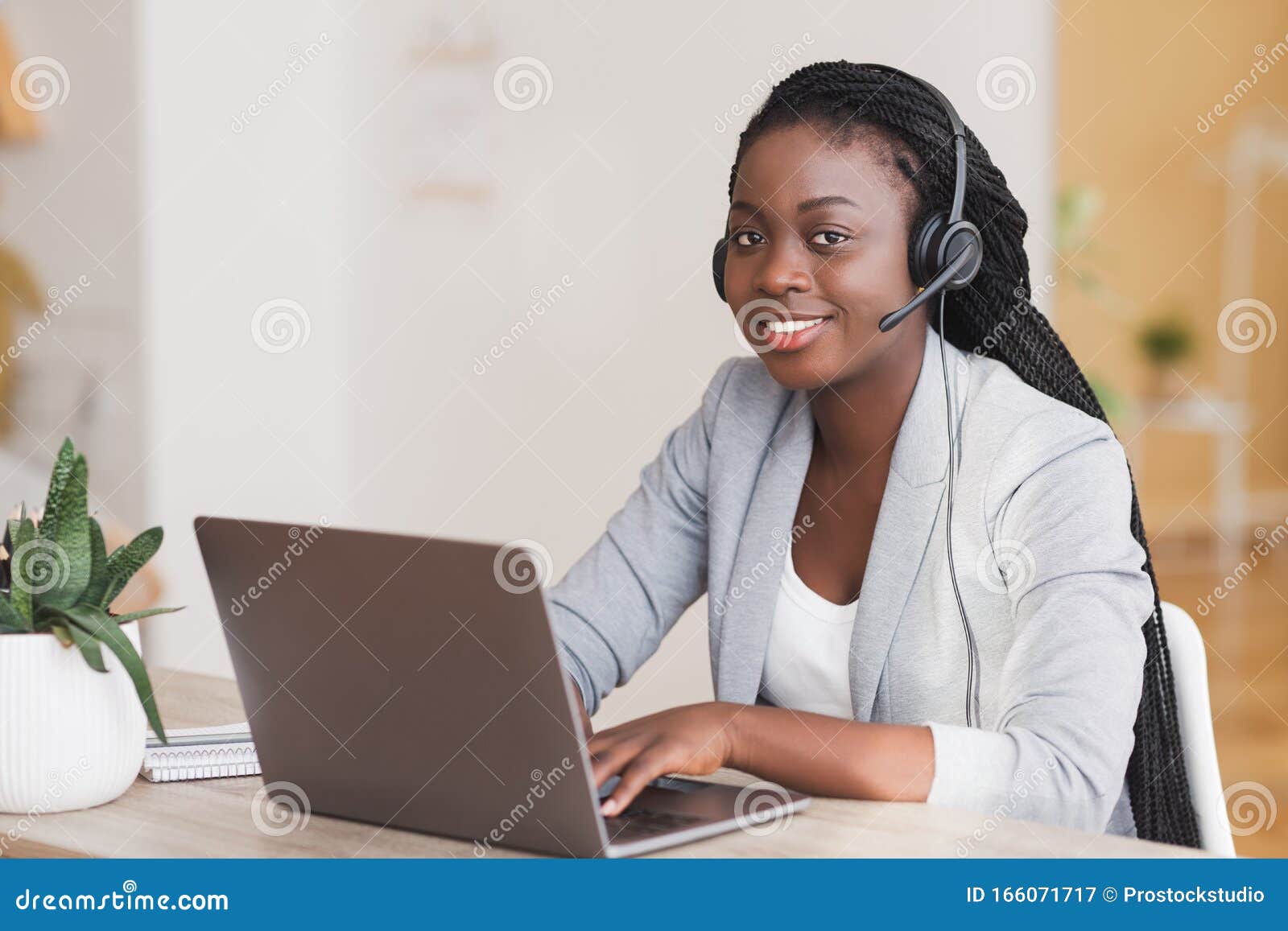 African Female Customer Support Operator Wearing Headset and Working on ...