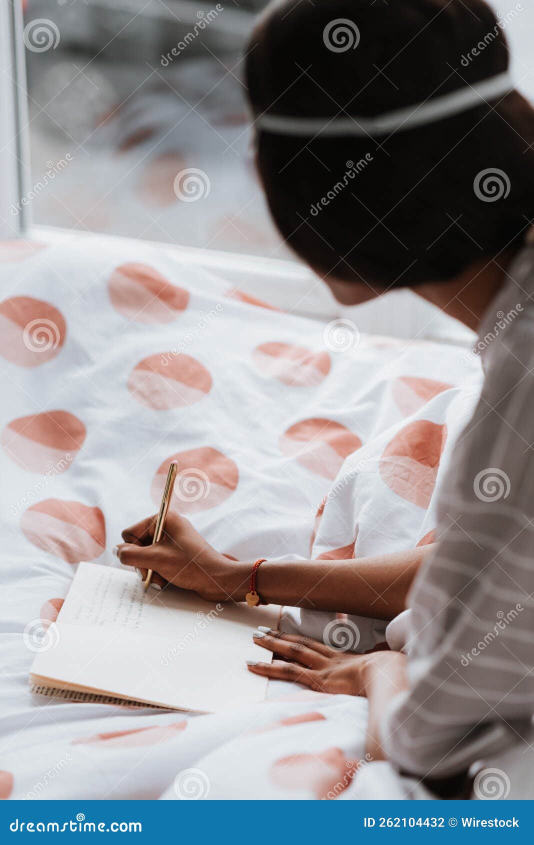 African Female Writing Notes in a Diary while Sitting on the Bed Stock ...
