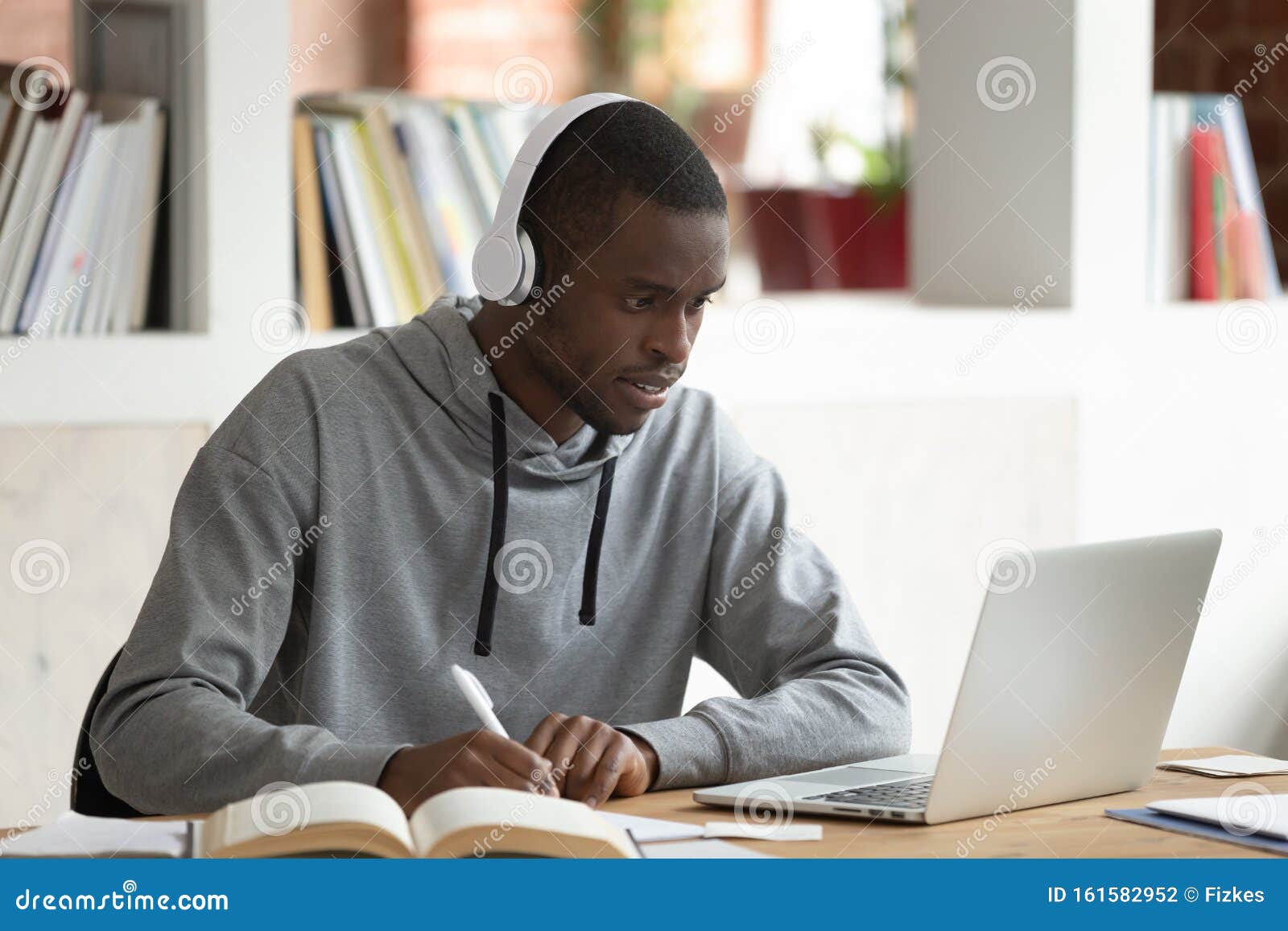 African Guy E-learning Seated at Desk in Public Library Stock Photo ...