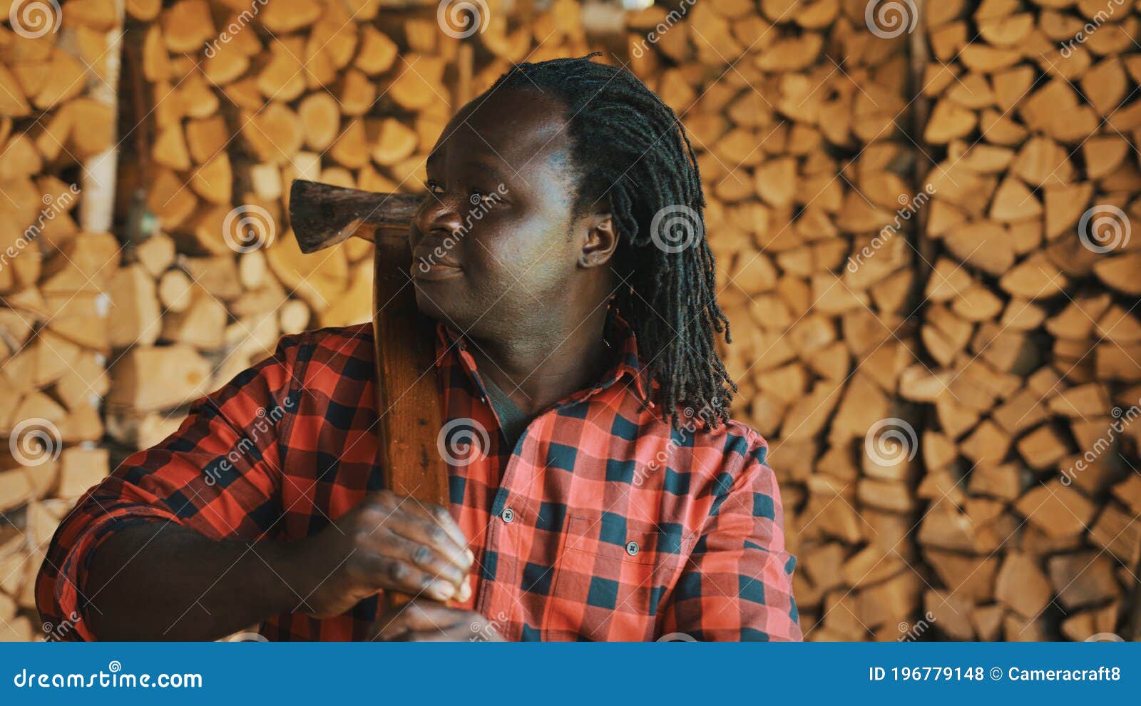African Man with the Axe Standing in Front of Stack of Cutted Timber ...