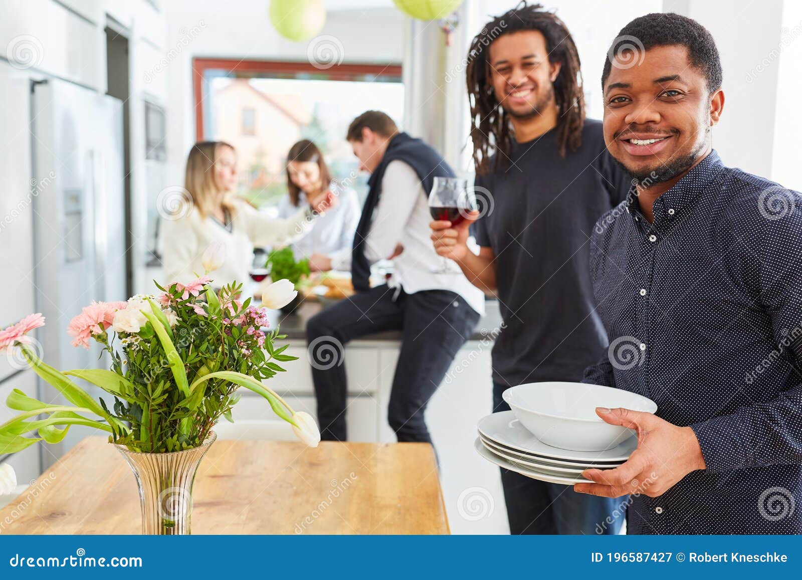 African Man with Dishes at Table Setting in Kitchen Stock Image - Image ...