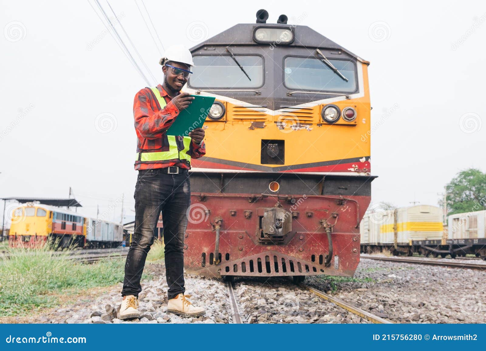 African Man Engineer Looking Report of Train Timetables for Control a ...