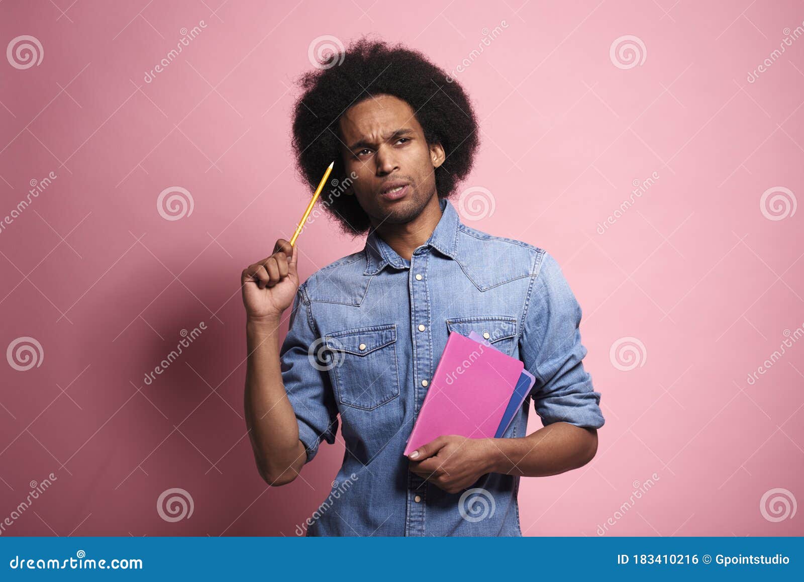 African Man Holding a Pencil and Thinking of Something Stock Photo ...