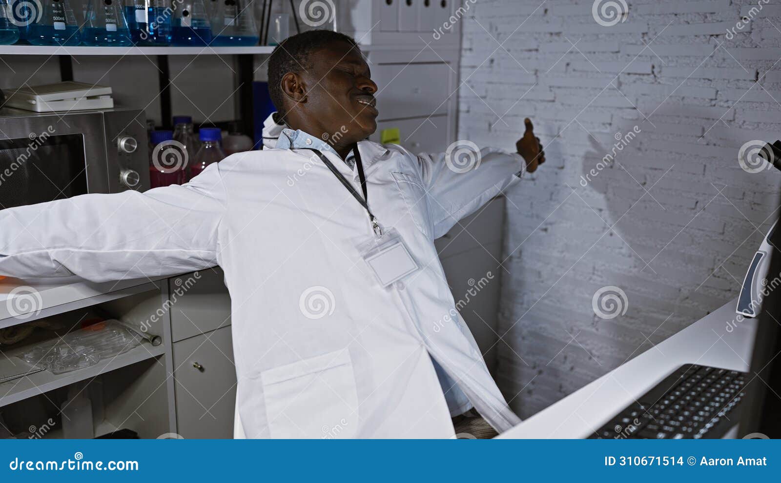 African Man in Lab Coat Stretching in a Modern Laboratory Setting with ...