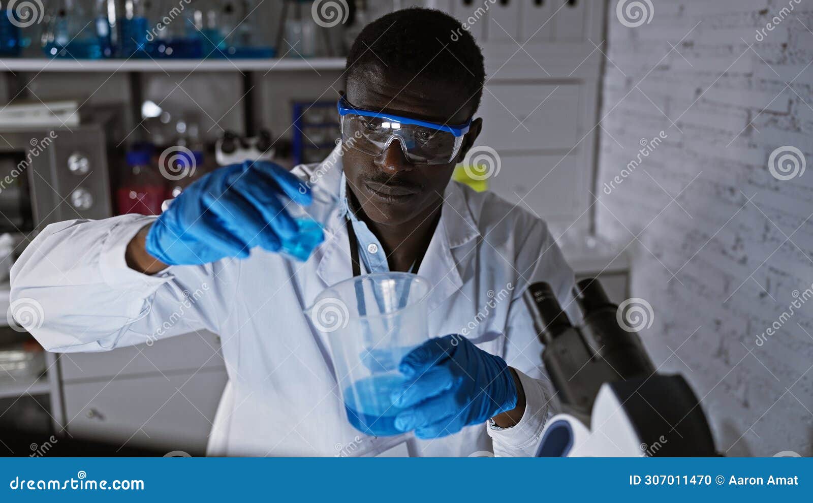 African Man in Lab Conducting Research with Beaker and Microscope Stock ...