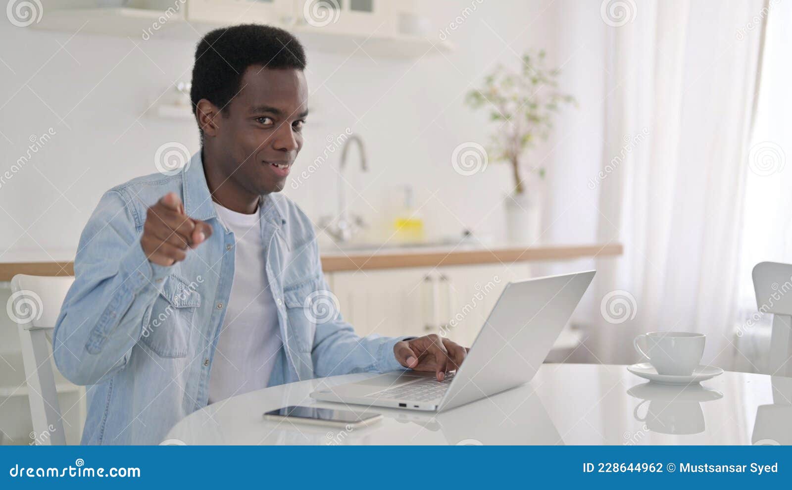 African Man with Laptop Pointing at the Camera Stock Photo - Image of ...