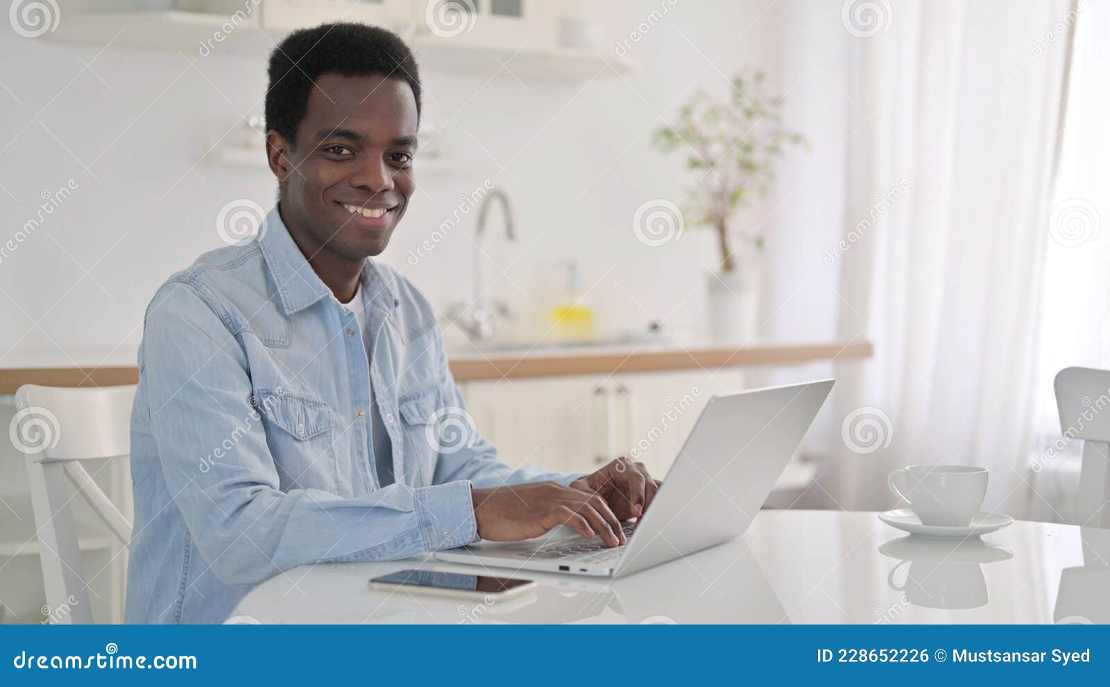 African Man with Laptop Smiling at the Camera Stock Photo - Image of ...