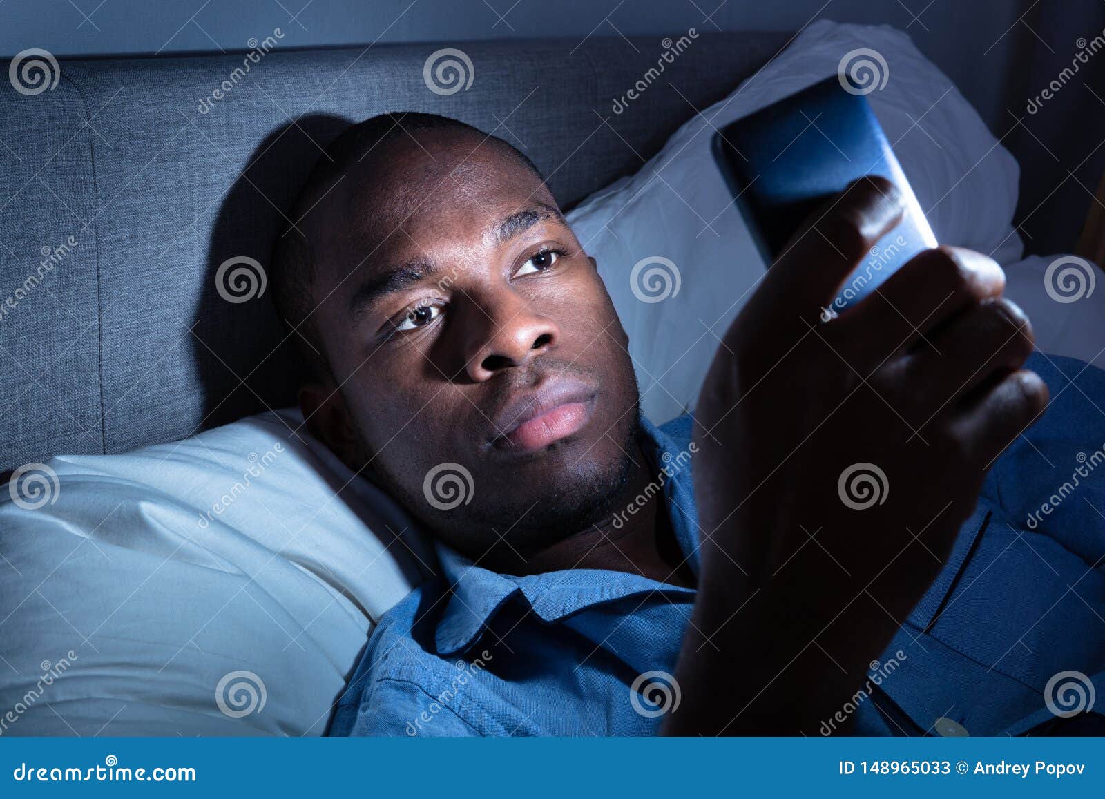 African Man Using Mobile Phone Stock Image - Image of duvet, afro ...