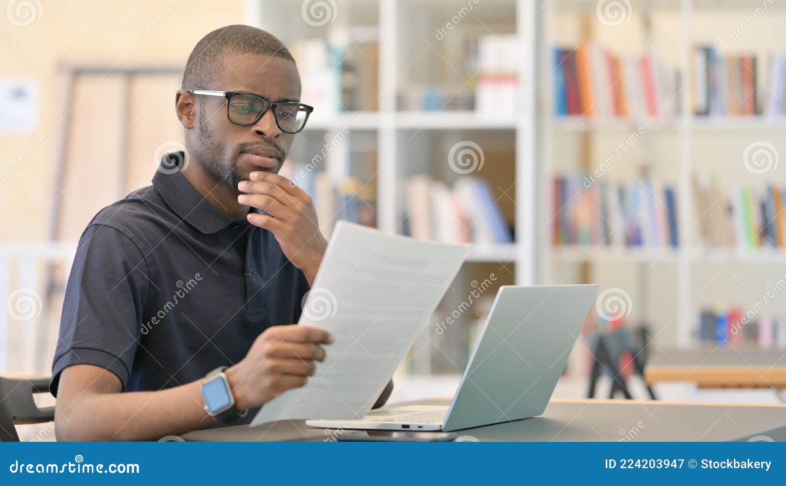 African Man Reading Documents, Paperwork in Library Stock Image - Image ...