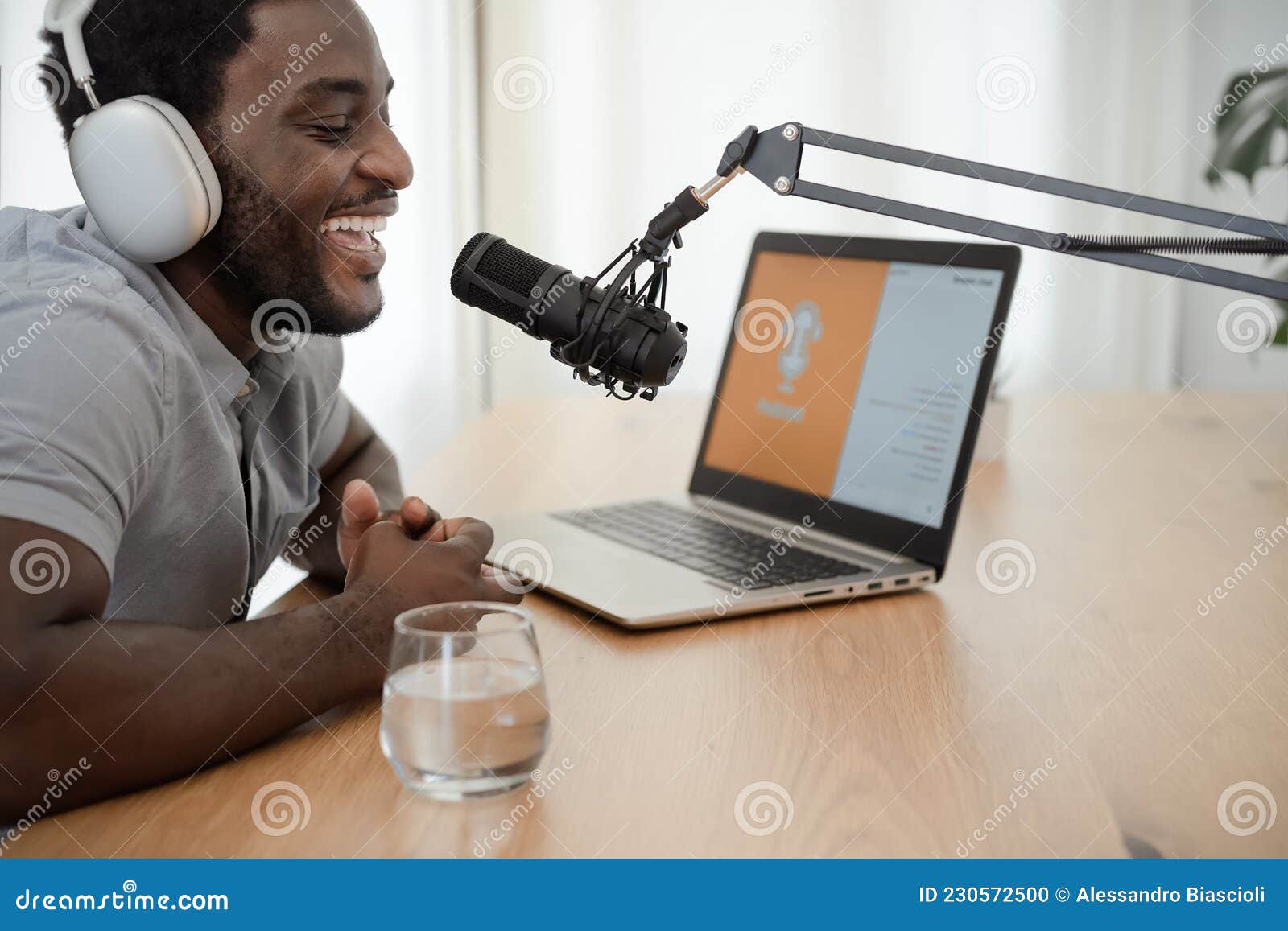 African Man Recording a Podcast Using Microphone and Laptop from Home ...