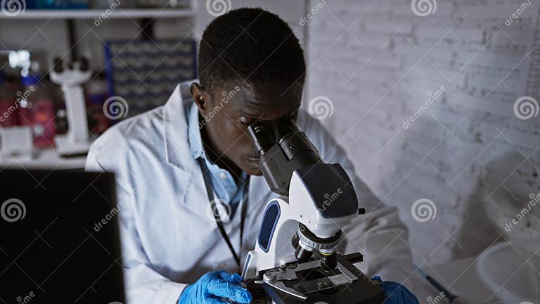 African Man Scientist Using Microscope in Laboratory Setting Stock ...