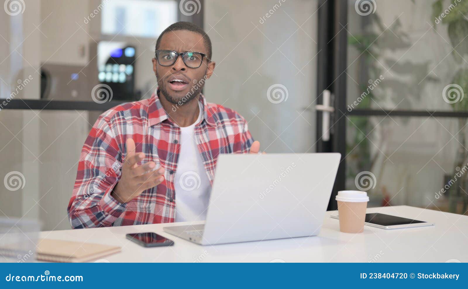 African Man in Shock Looking at Camera while Using Laptop Stock Photo ...