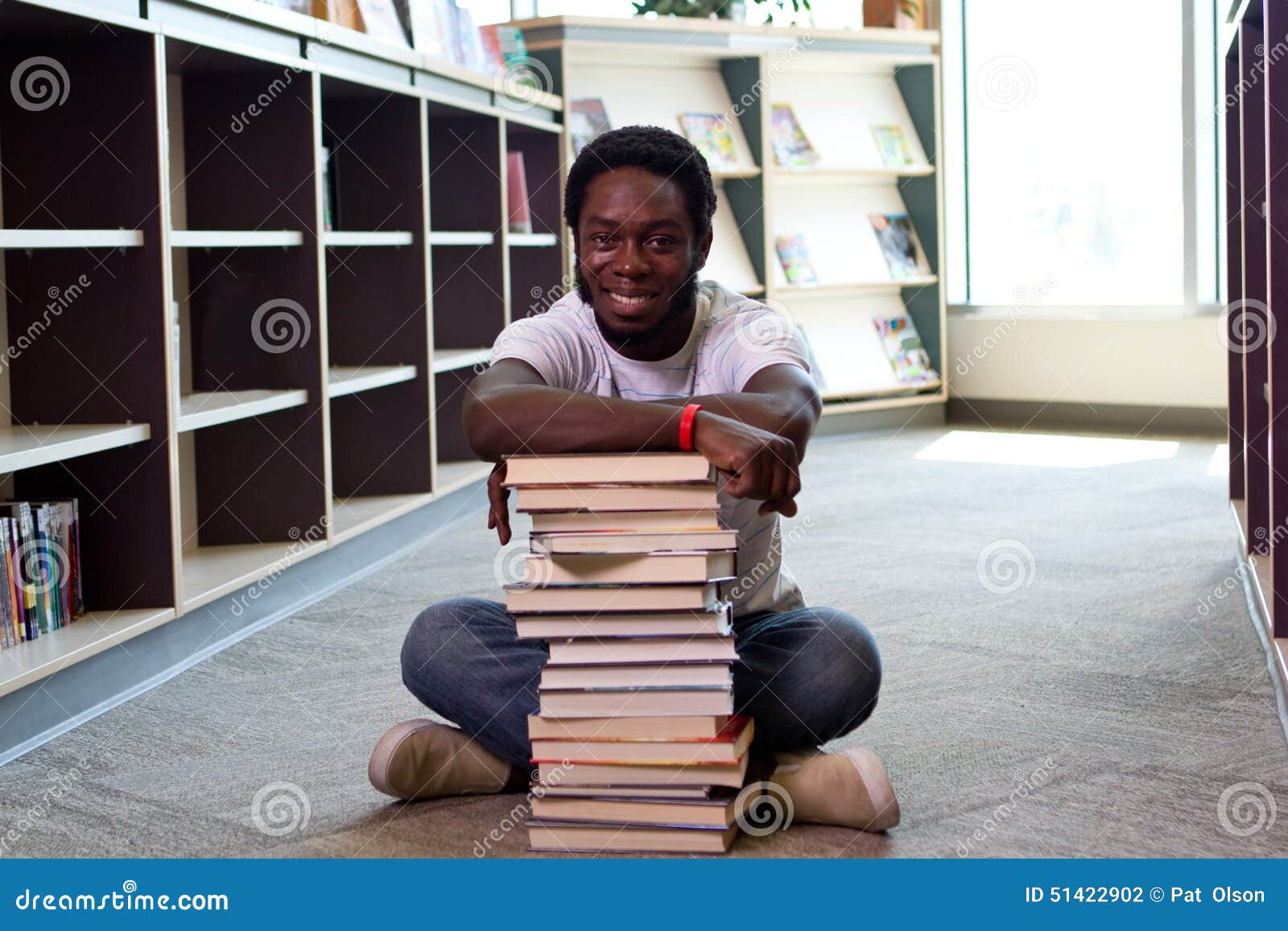 African Man Sitting on Floor at Library Stock Photo - Image of ...