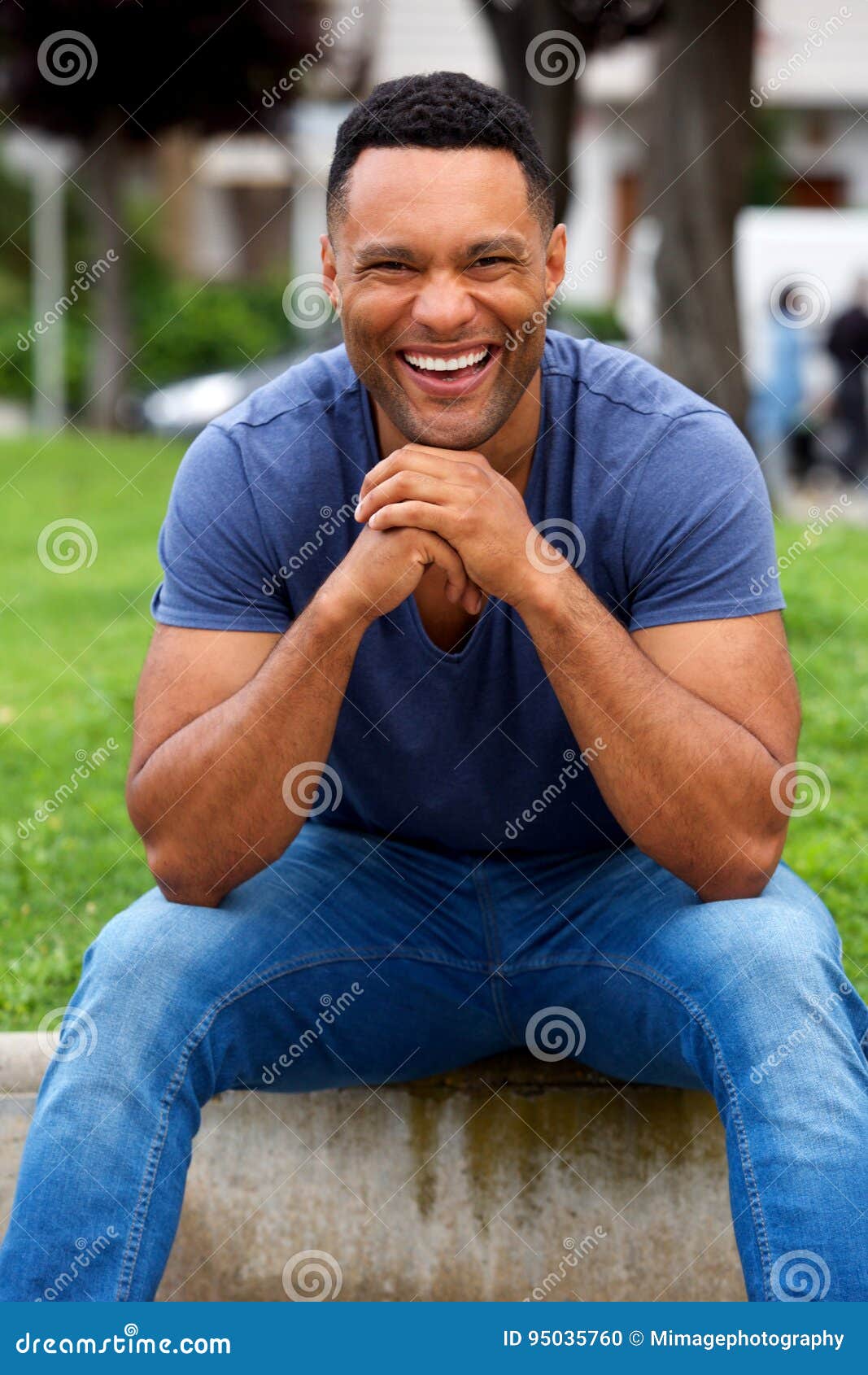 African Man Sitting Outdoors and Laughing Stock Photo - Image of ...
