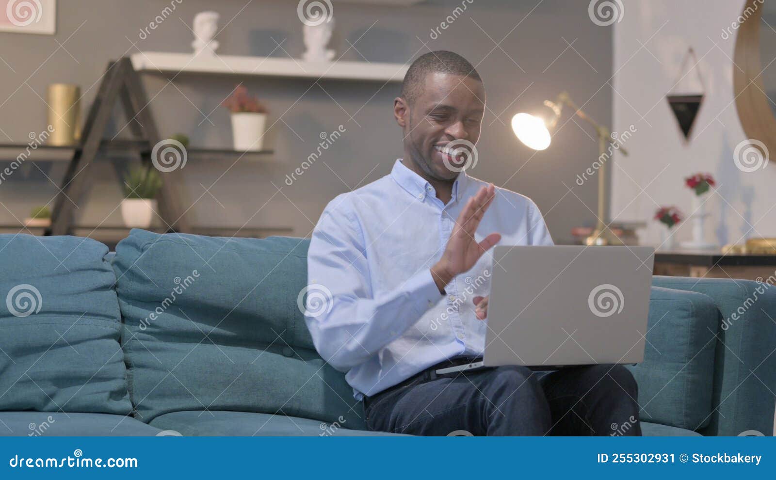 African Man Talking on Video Call on Laptop on Sofa Stock Image - Image ...