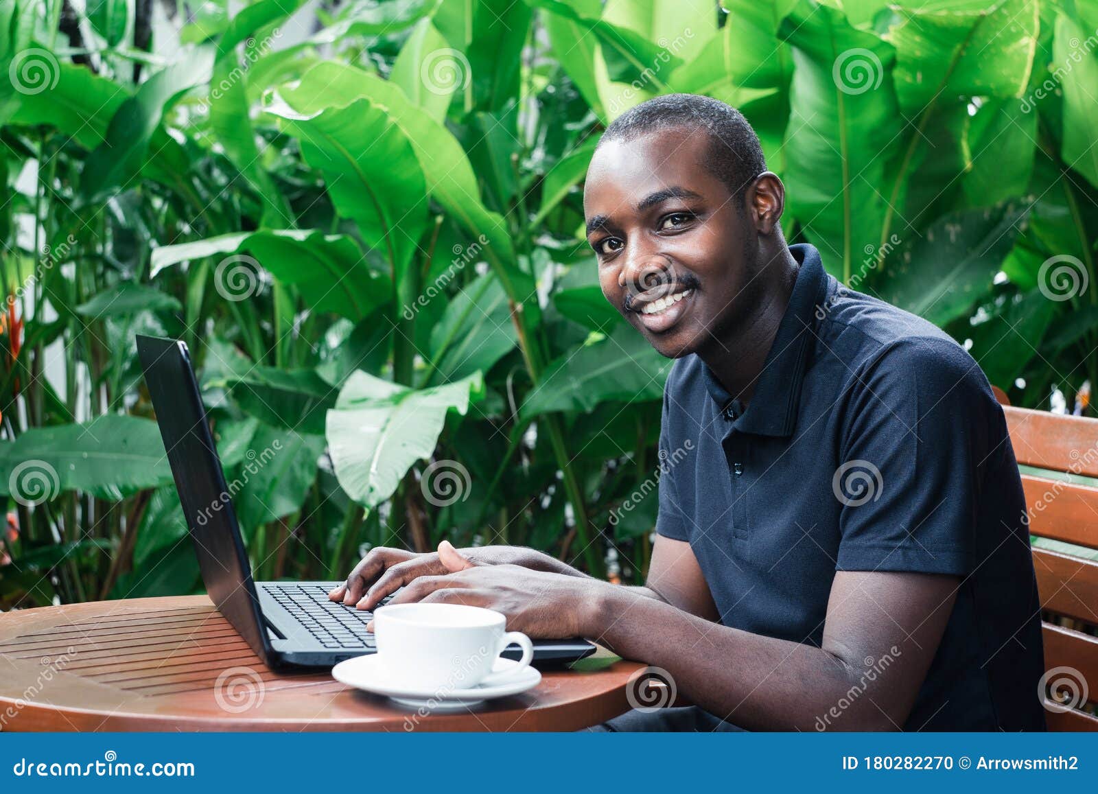 African Man Using a Laptop Computer Outside a Coffee Cafe Stock Photo ...