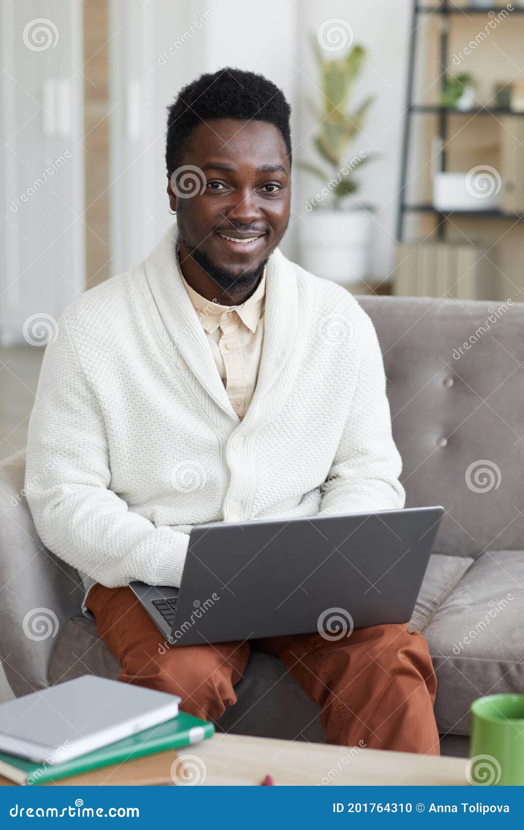 African man using laptop stock photo. Image of house - 201764310
