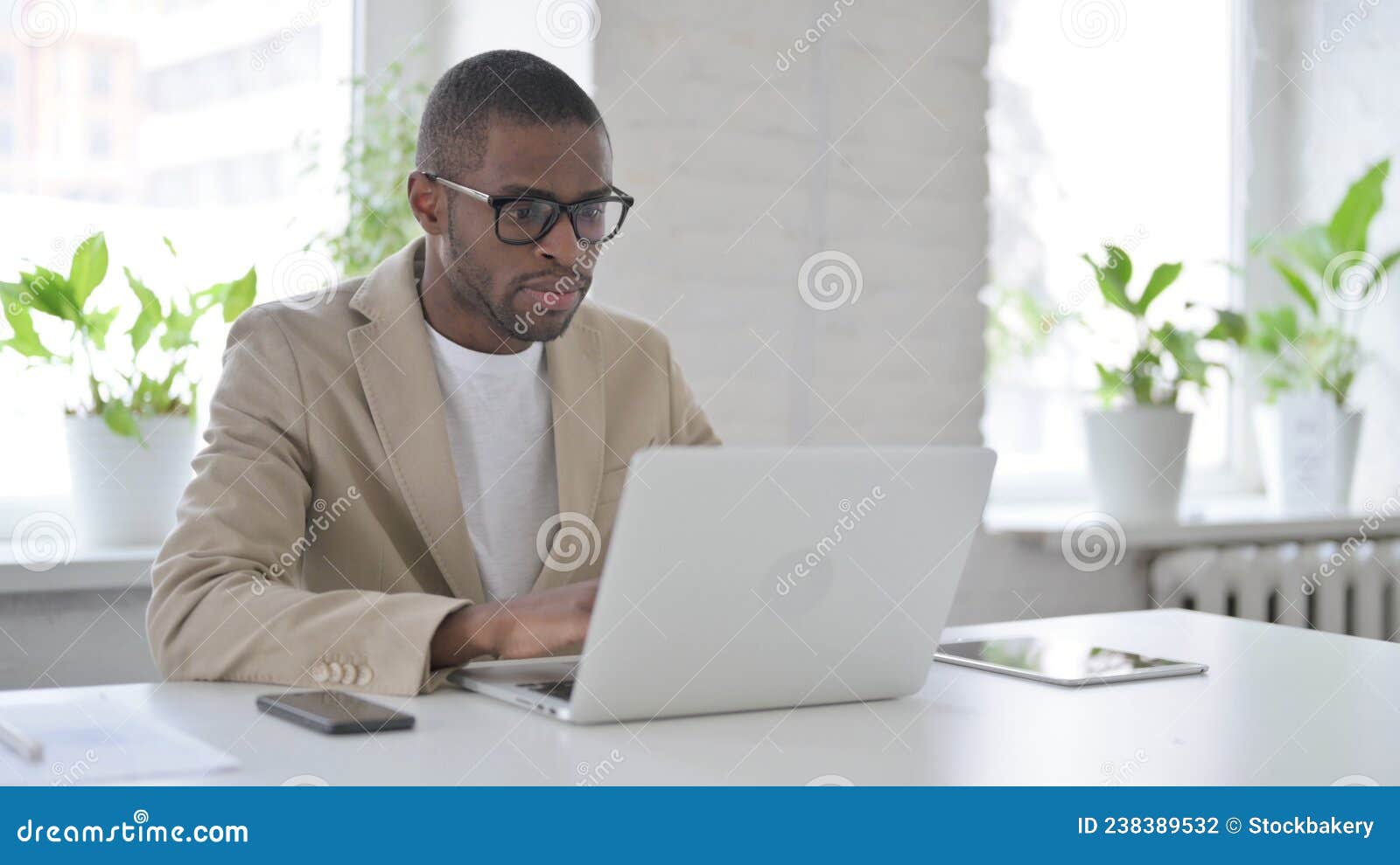 African Man Working on Laptop in Office Stock Photo - Image of laptop ...