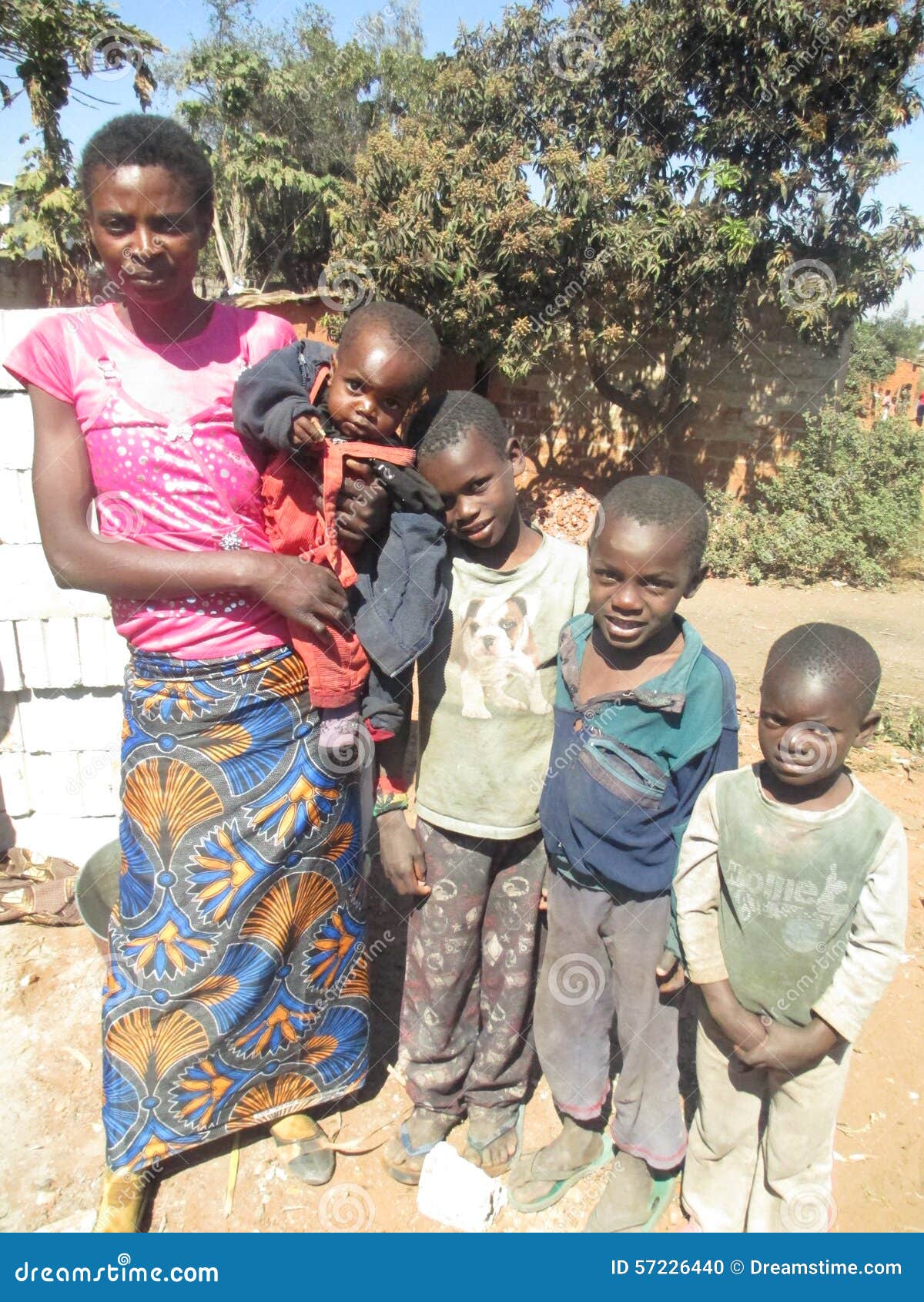 African Mother Carrying Her Daughter On Her Back In Traditional African ...