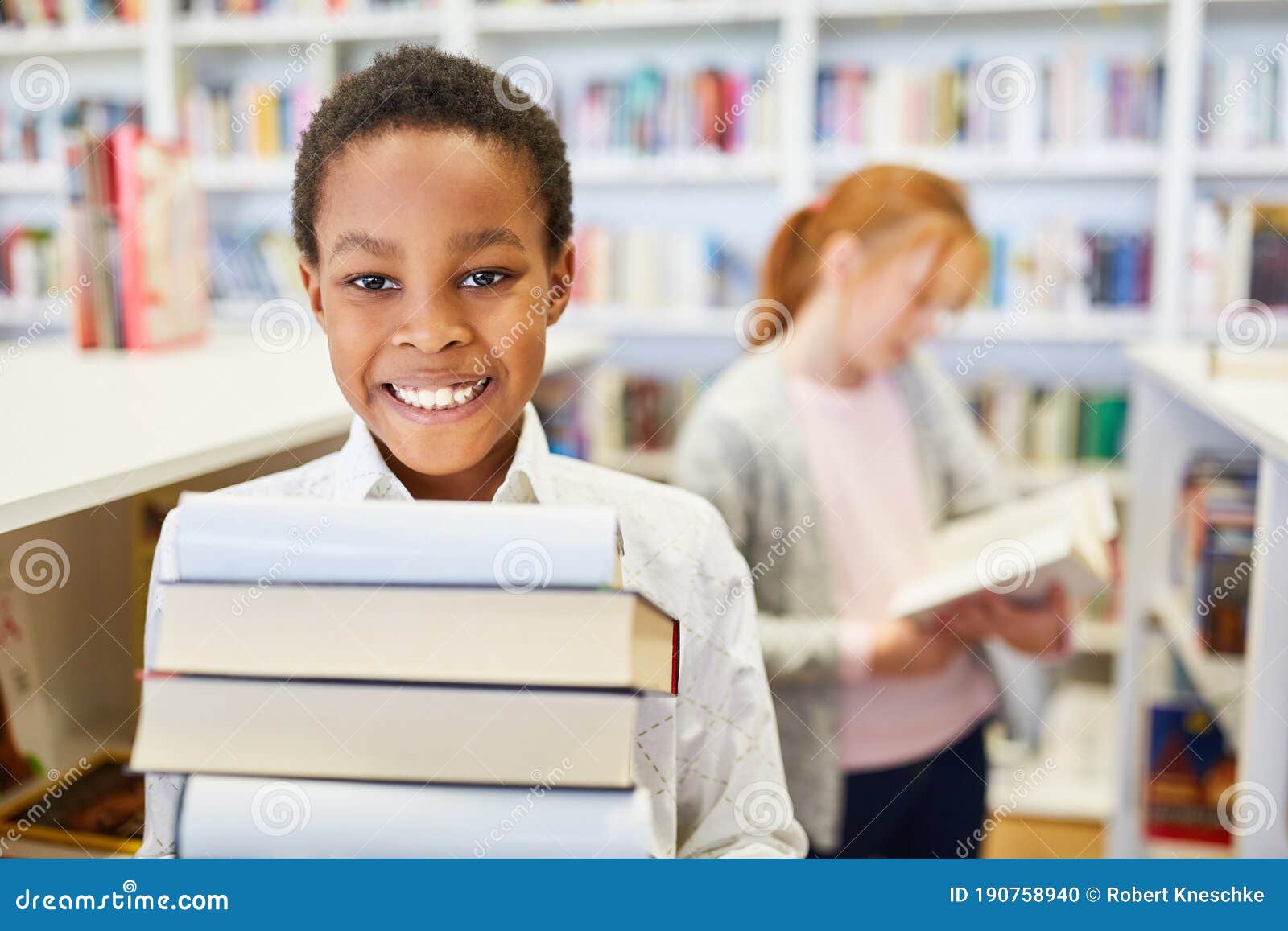 African Pupil with a Stack of Books Stock Photo - Image of lend, books ...