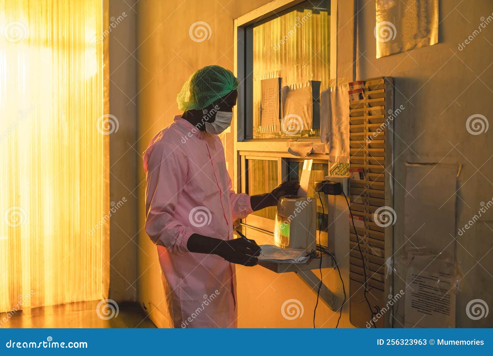 African Quality Control Employee Man in Sterile Suit Clock in with Time ...