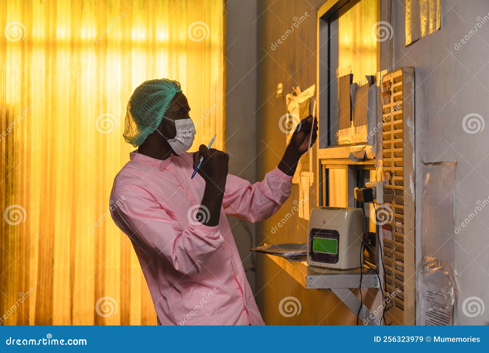 African Quality Control Employee Man in Sterile Suit Clock in with Time ...