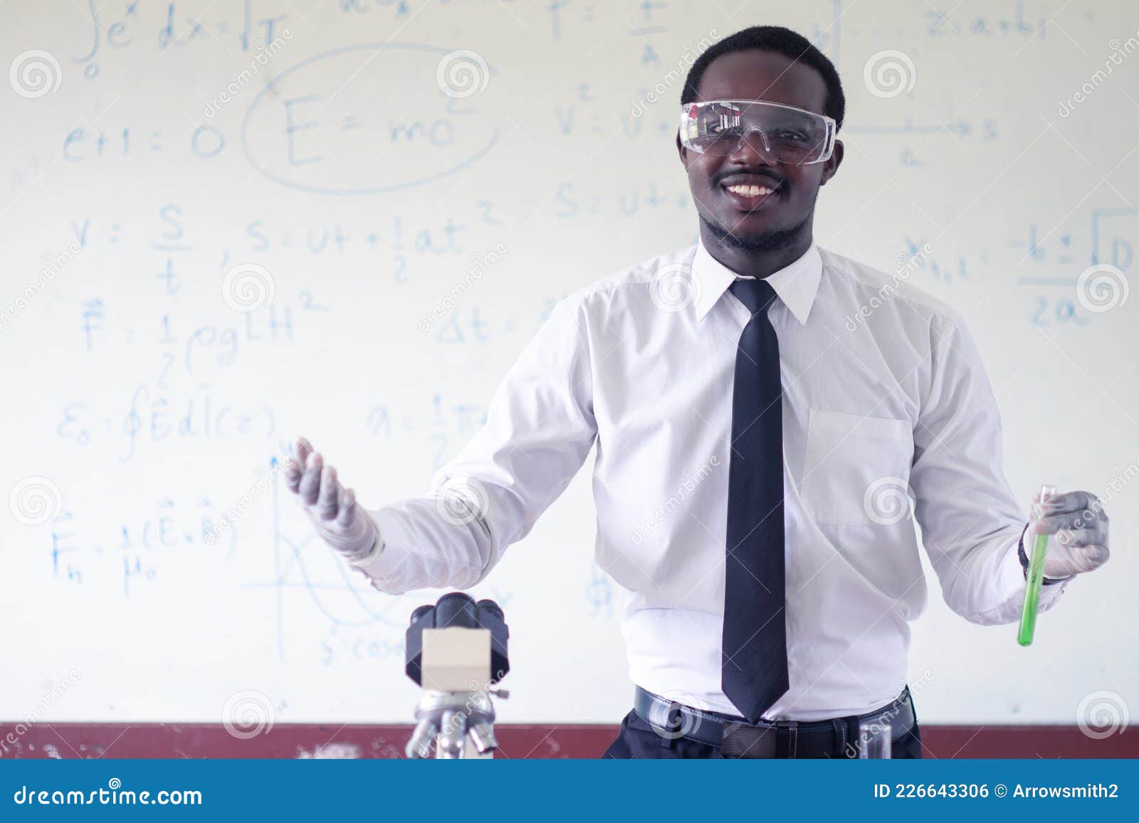 African Scientist Teacher is Holding Test Tube with Chemical Liquid ...