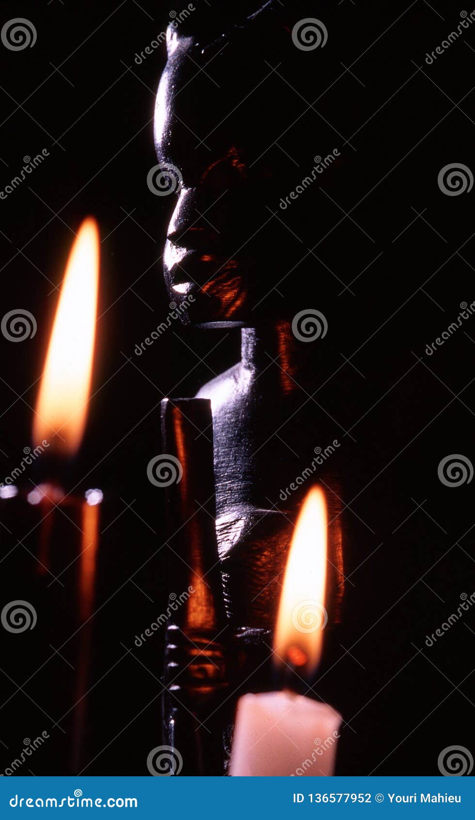 African statue with candle stock photo. Image of africa - 136577952